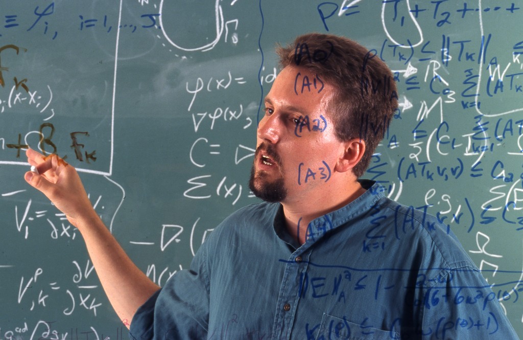 Professor Michael Holst, standing in front of a chalkboard. — Calisphere