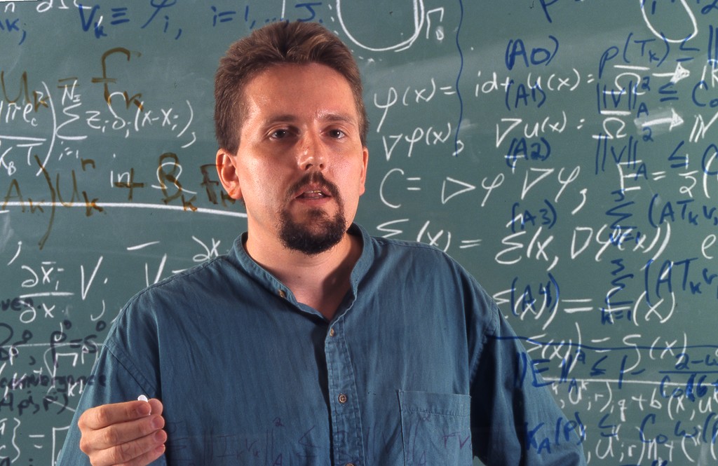 Professor Michael Holst, standing in front of a chalkboard. — Calisphere