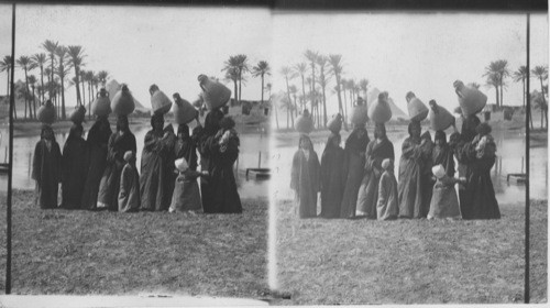 Water Carriers at the Nile, Pyramids in Distance, Gizeh, Egypt — Calisphere