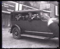 Two policemen in car aiming machine guns out window, Los Angeles, circa ...