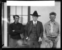 U. S. Marshal Robert E. Clark stands between a man and a teenager, Los ...