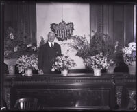 Judge Benjamin Franklin Bledsoe next to flower arrangements, Los ...
