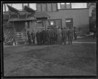 Men gathered outside the home of Jacob Denton, who was found murdered ...