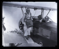 Edith Weber on the wing of an airplane with two men in pilot seats, Los ...