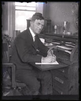 Playground Superintendent Charles B. Raitt writes at his desk, Los ...