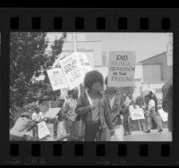Jonathan Peter Jackson (face obscured by sign) walking with Angela ...