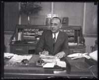 George Bierman signing papers at his desk, Los Angeles, 1926-1931 ...