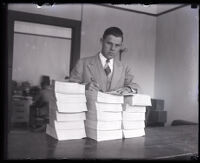 Judge Samuel R. Blake holding a pen over three stacks of transcripts ...