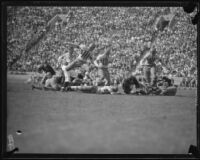 USC's Orv Mohler stumbles as he carries the football through Utah's ...