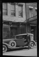 Nevada Governor Fred B. Balzar standing next to a car parked outside ...