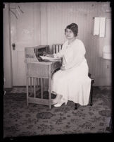 Minnie Kennedy sitting at desk with a book, Los Angeles, 1926-1932 ...
