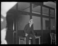James Sayers sitting down on table in office hallway, Los Angeles, 1935 ...