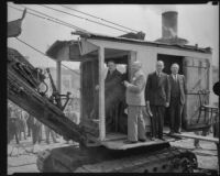 Mayor Frank L. Shaw at the helm of a steam shovel with 3 other men at ...