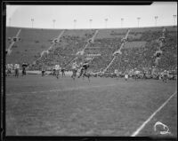 Players jostle for position near the 55-yard-line during a football ...