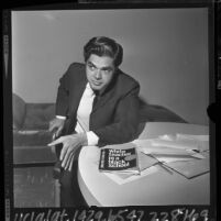 Fired teacher Robert Kendall posing with book he authored in Woodland ...