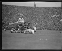 Trojan quarterback, Mickey Anderson, watches as Duke's defenders tackle ...