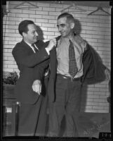 Richard Cantillon assisting F. Raymond Groves with his jacket, Los ...