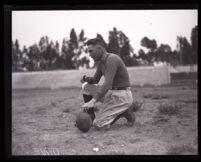 Football player and coach Albert Andrew Exendine holds the football in ...