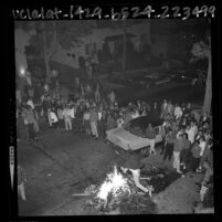 UCLA students gathering around bonfire set ablaze on residential street ...