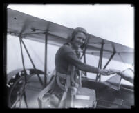 Mary Wiggins, wearing parachute pack and smiling as she climbs onto ...