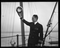 Commander Richard E. Byrd waves goodbye as the C. A. Larson departs ...