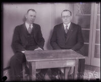 Police detective E. Raymond Cato and David Davidson sitting behind a ...