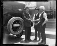 State Treasurer Friend W. Richardson shaking hands with two men, 1922 ...