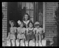 June Robles with unidentified children and a young woman, on a visit to ...