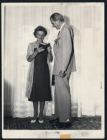 Aldous Huxley with Laura Huxley holding a book [descriptive] — Calisphere