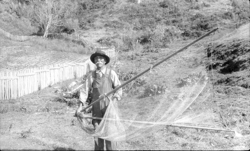 Yurok male holding "A-frame" fish net — Calisphere