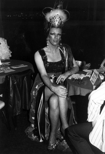 Female impersonator wearing a party hat — Calisphere