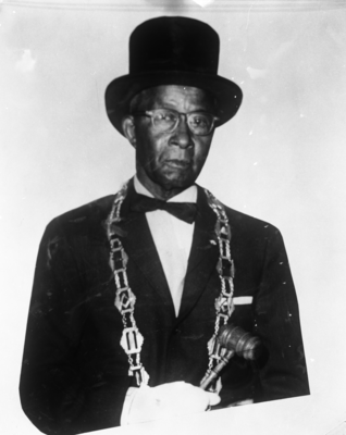 Portrait of mason wearing top hat and masonic chain holding gavel ...