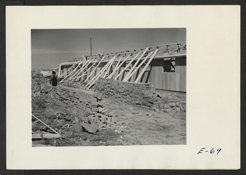 Contractor's construction crews assembling the roof structure on a ...