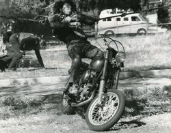 Chuck Waters clothesline stunt on motorcycle — Calisphere