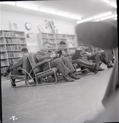 Williams and others reading in the library at Fort Ord — Calisphere