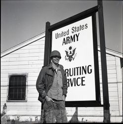 Soldier standing in front of Army Recruiting Service sign at Camp ...