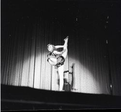Contortionist performing on stage at or near Fort Ord — Calisphere