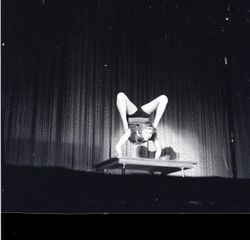 Contortionist performing on stage at or near Fort Ord — Calisphere