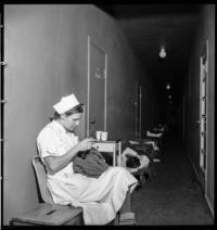 Viipuri Hospital [Nurse sewing, patients on stretchers in hallway ...