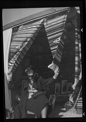 Souvenir stand with hanging sarapes, Tijuana, 1931 — Calisphere
