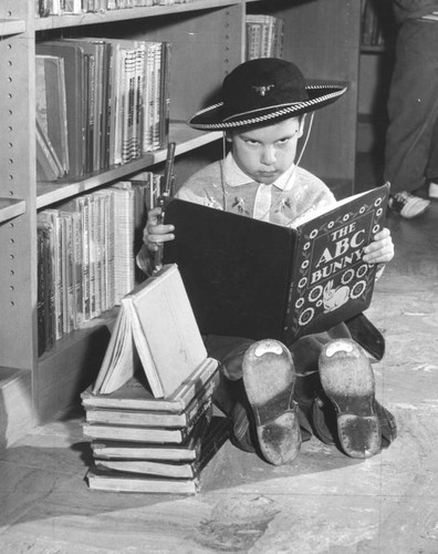 Philip Ross reading library book — Calisphere