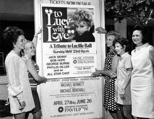 Women in front of tribute poster to Lucille Ball — Calisphere