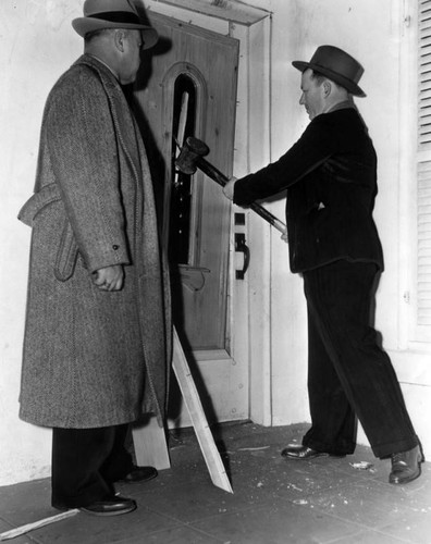 Officer's use sledge hammer to open doors — Calisphere