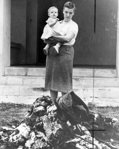 Mrs. Sears and Roberta survey remains of divan — Calisphere