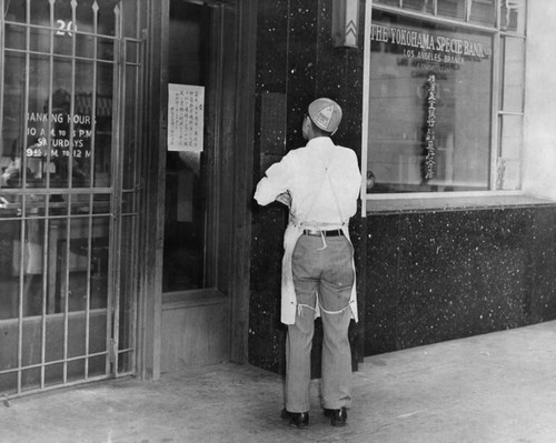 Reading notice at bank — Calisphere