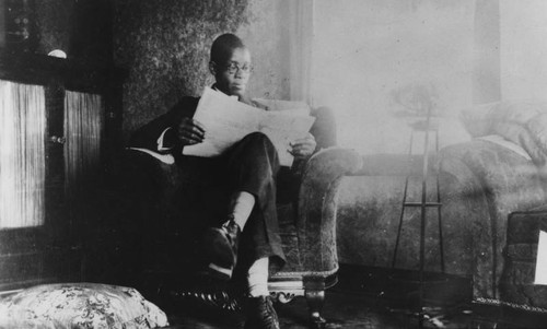 Man reading a newspaper — Calisphere