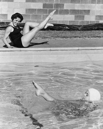 Betty Vickers, rear, instructs pupil in precision swimming — Calisphere