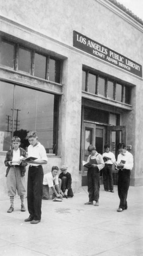 Boys reading in front of the Henry Adams Branch — Calisphere