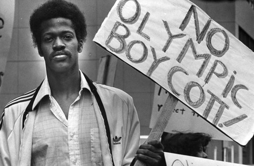 Willie Banks holds a "no boycott" sign — Calisphere