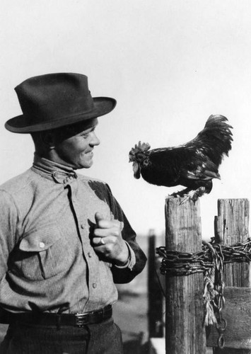 Man with chicken — Calisphere